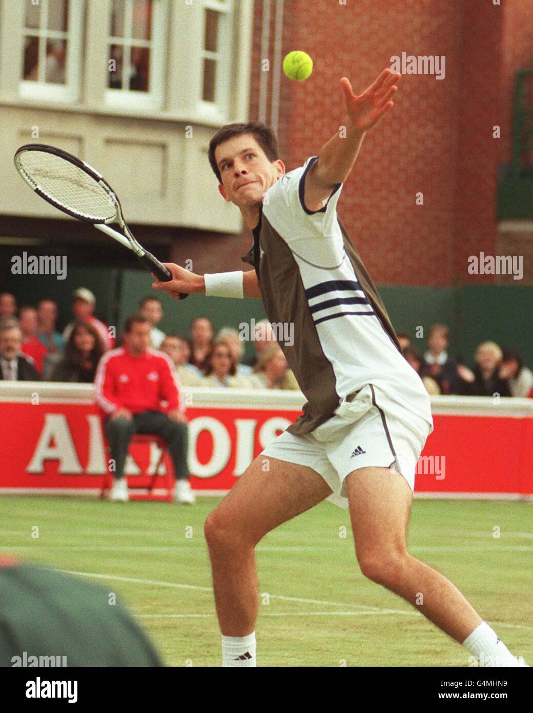 Tim Henman (Great Britain) celebrates by hitting the ball into the ...