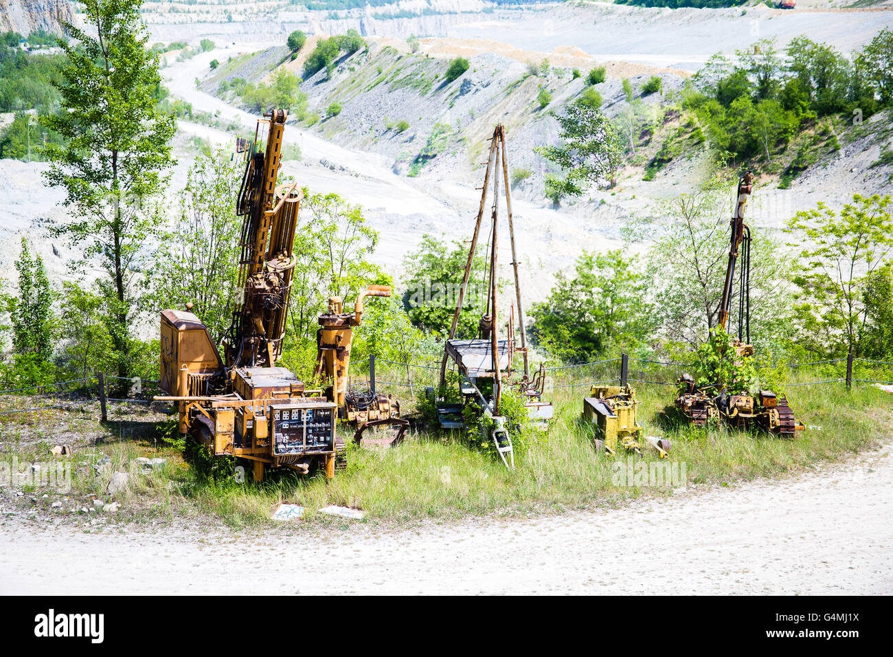 big mine pit with mining Excavator machinery Stock Photo - Alamy