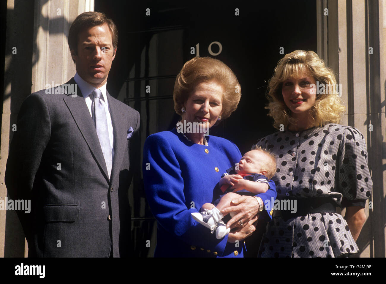 Prime Minister Margaret Thatcher cradles her grandson Michael outside ...