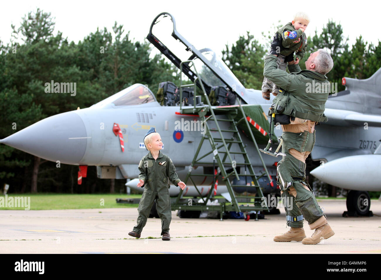 Wing Commander Andy Turk from 9 Squadron is greeted by his two children ...