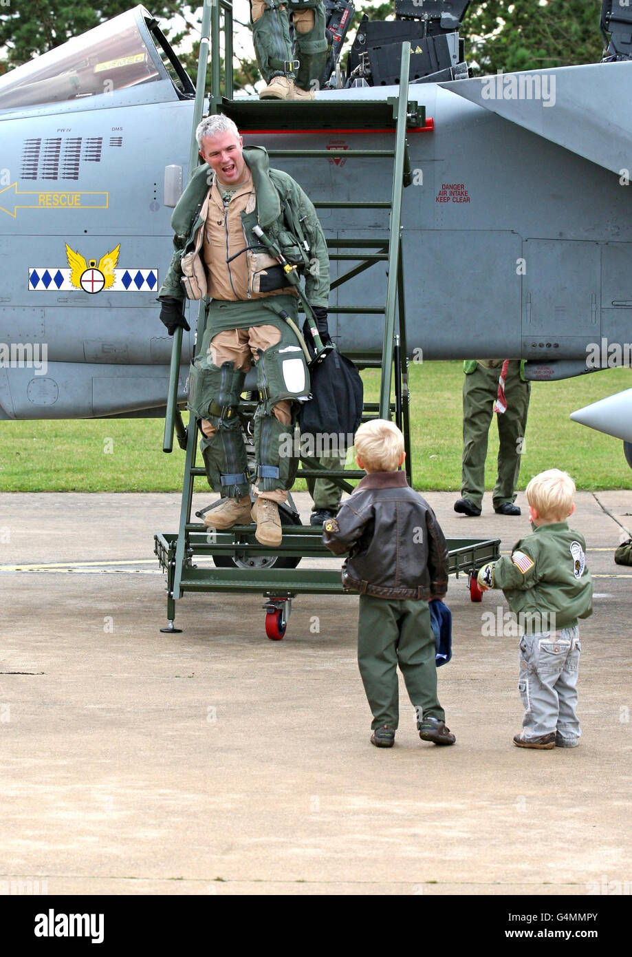 Wing Commander Andy Turk from 9 Squadron is greeted by his two children ...