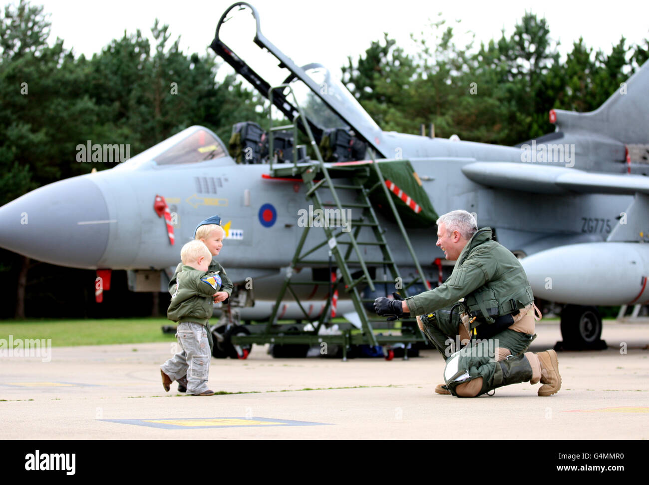 Wing Commander Andy Turk from 9 Squadron is greeted by his two children ...