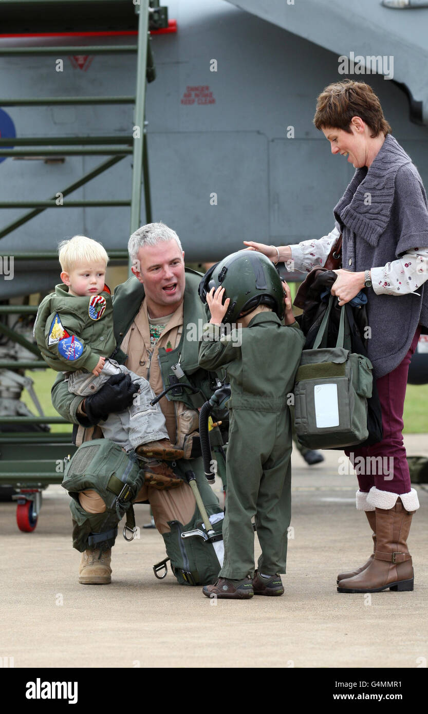Wing Commander Andy Turk from 9 Squadron is greeted by his wife Abi ...