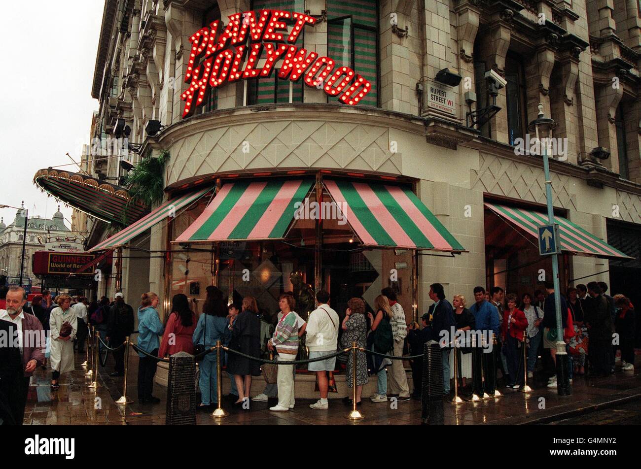Customers queue at the Planet Hollywood restaurant in Piccadilly ...