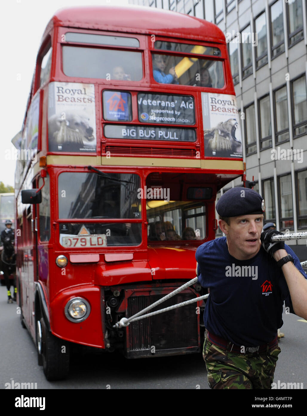 A team of 10 police officers and 10 members of the Armed Forces pull a ...