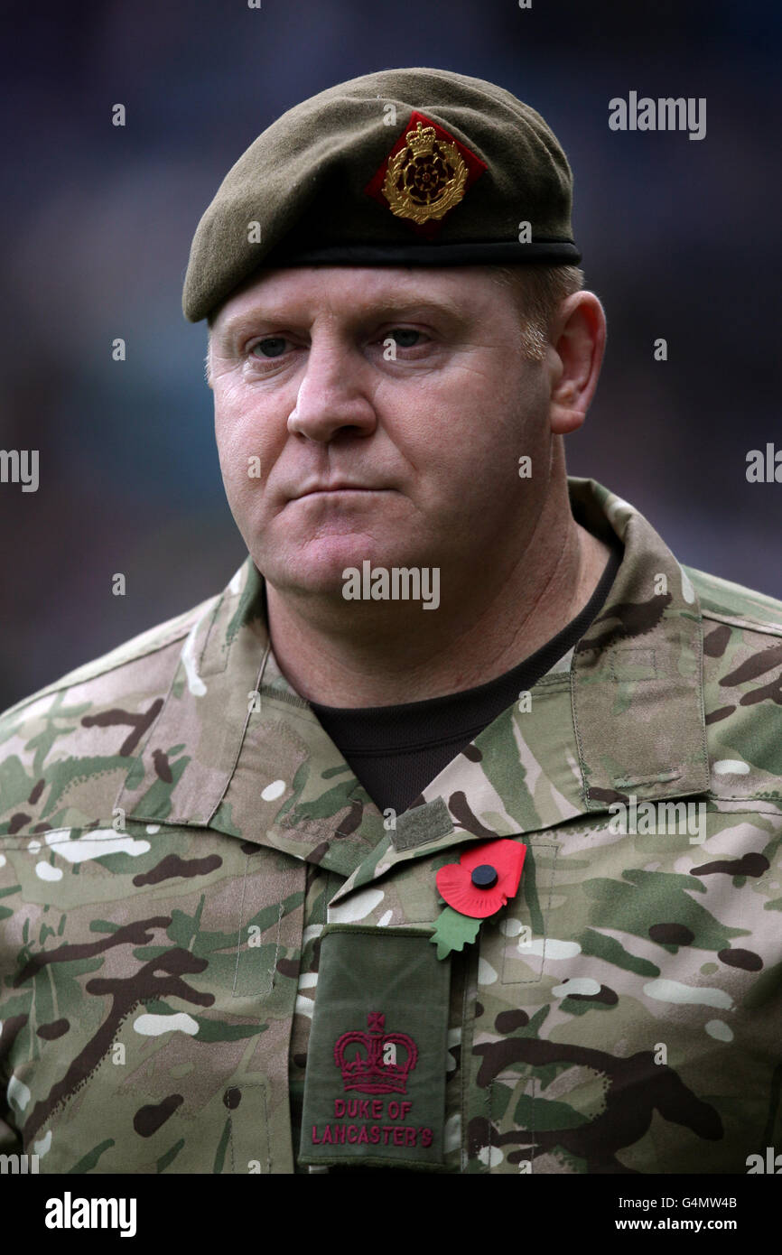 A member of the Duke of Lancaster's regiment wears a poppy on his ...
