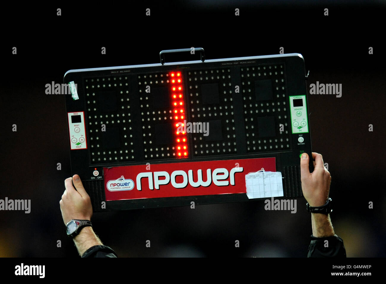 The referee's assistant holds up an electronic board indicating 1 ...