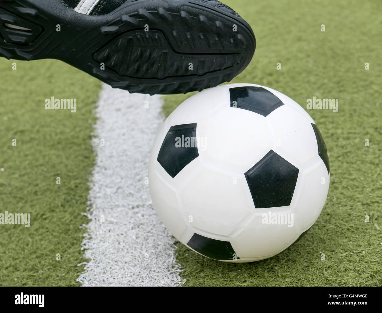Soccer player doing kick with ball on football stadium field Stock ...