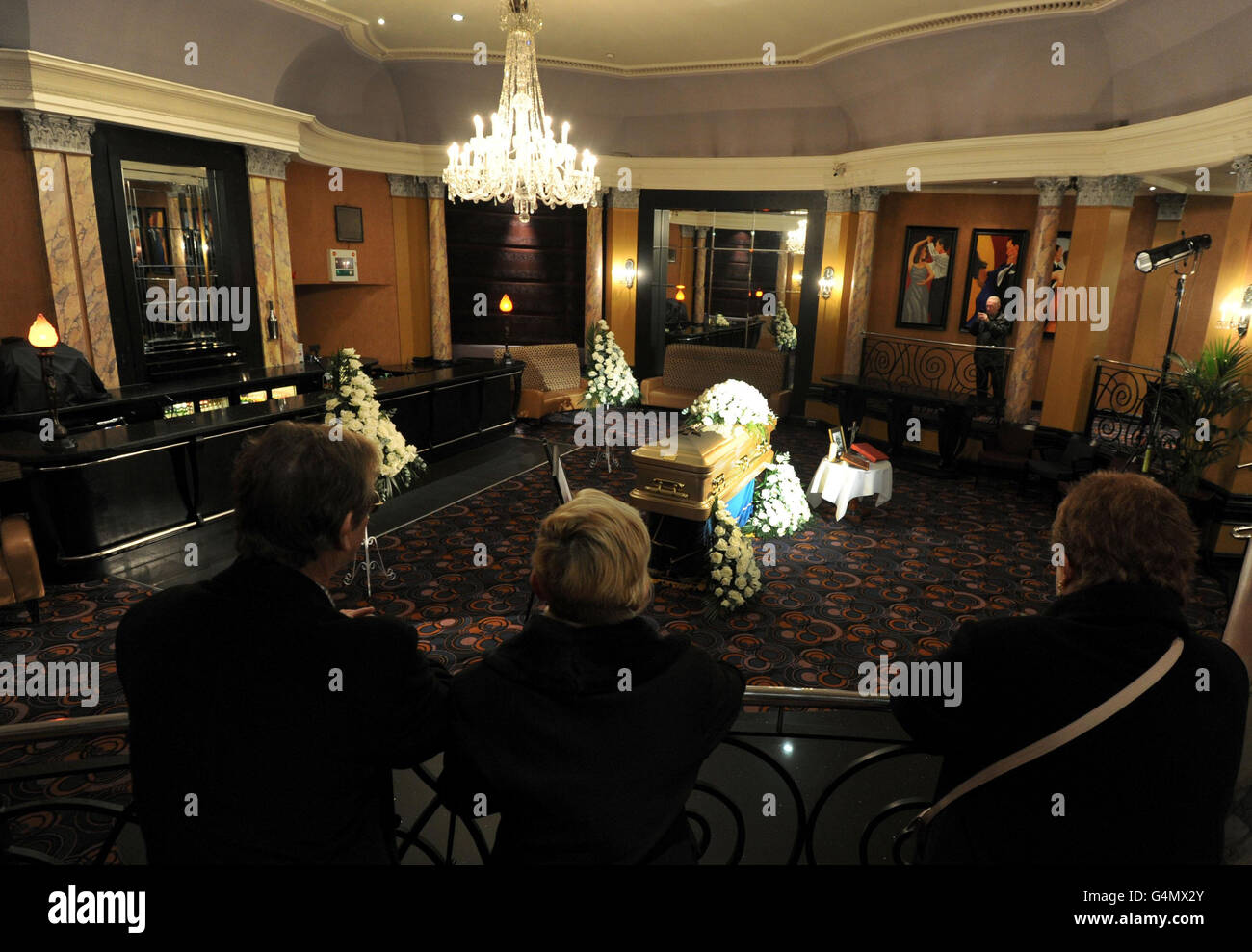 Members of the public view the golden coffin of Sir Jimmy Savile inside ...