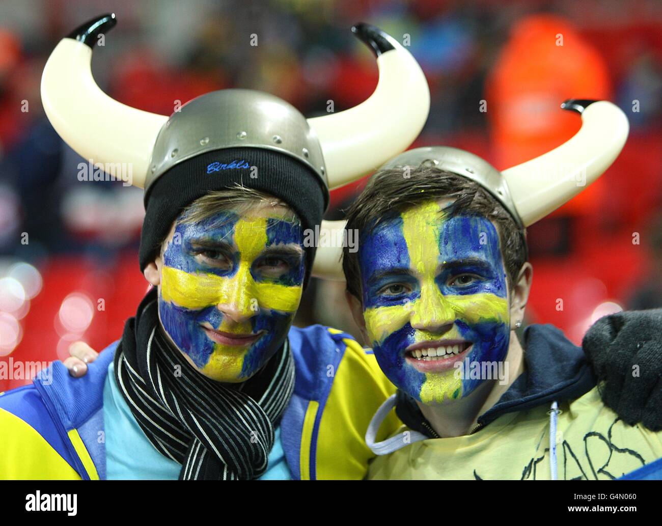 Sweden fans wearing face paint cheer on their side in the stands Stock ...