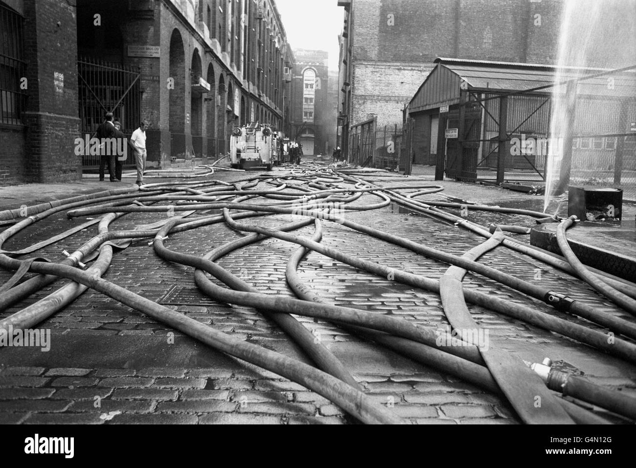 Hoe pipes of firemen still at work on the disused cold storage depot at ...