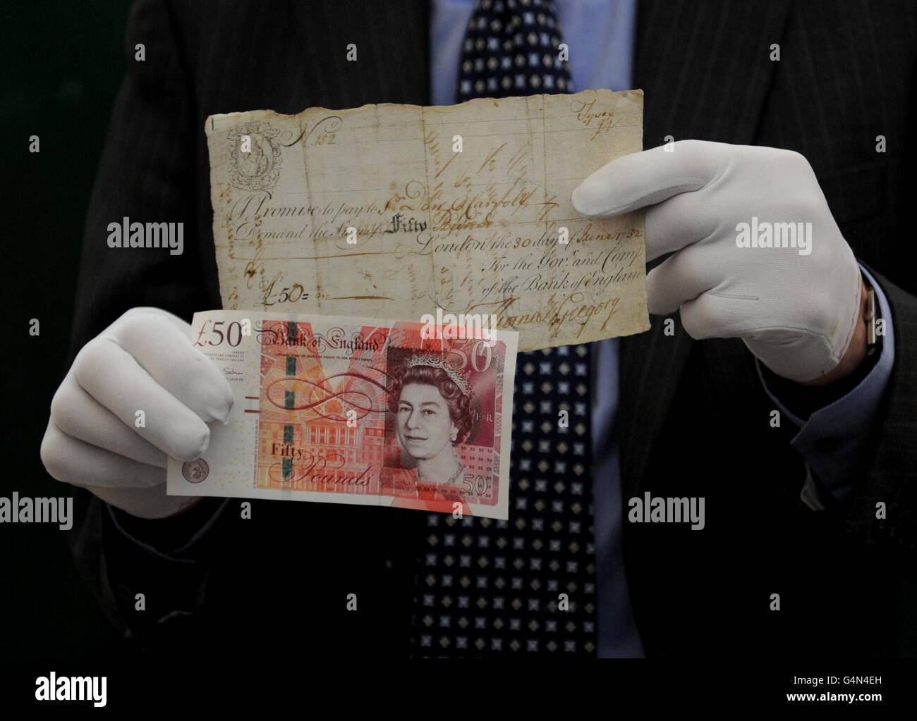 The oldest surviving £50 note (above) is pictured with the new £50 note ...