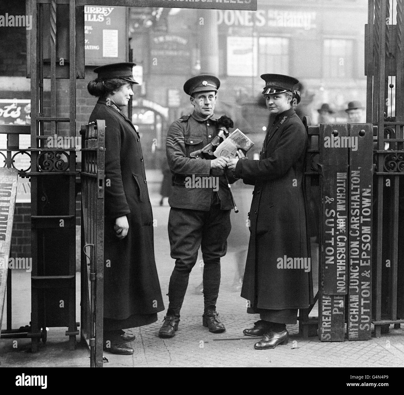 Women ticket collectors checking the ticket of a British soldier at ...