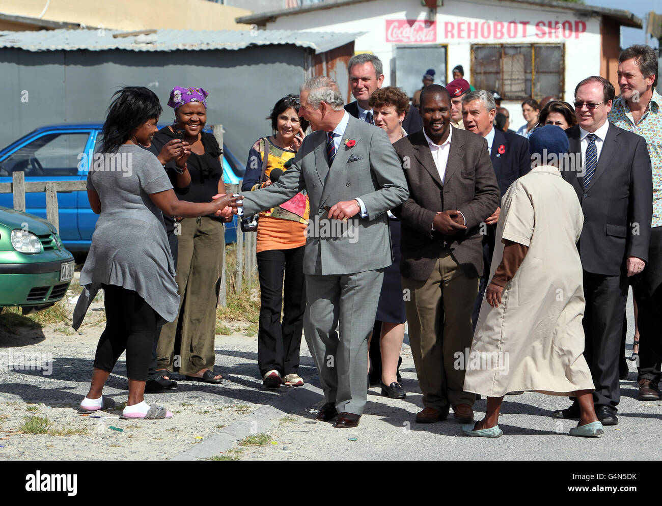 The Prince of Wales meets locals as he walks through the Kuyasa ...