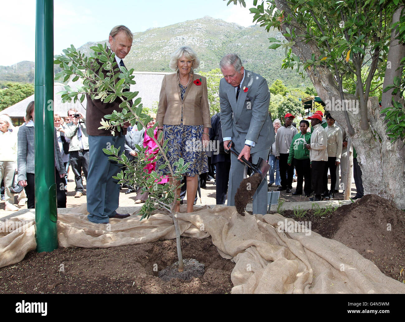 Prince Charles and the Duchess of Cornwall plant a milkwood tree during ...