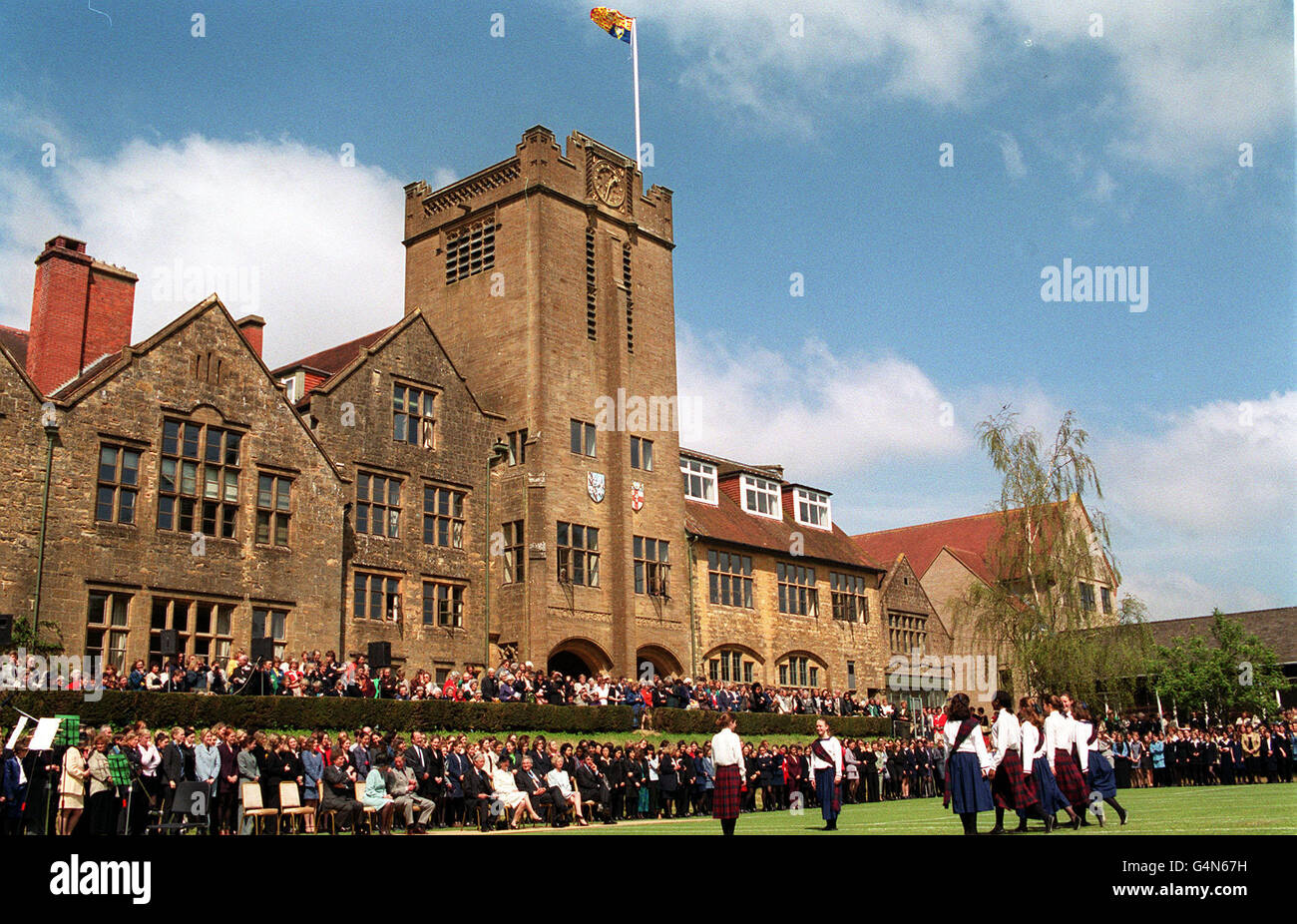The Prince of Wales (front row, light grey suit) watches a display of ...