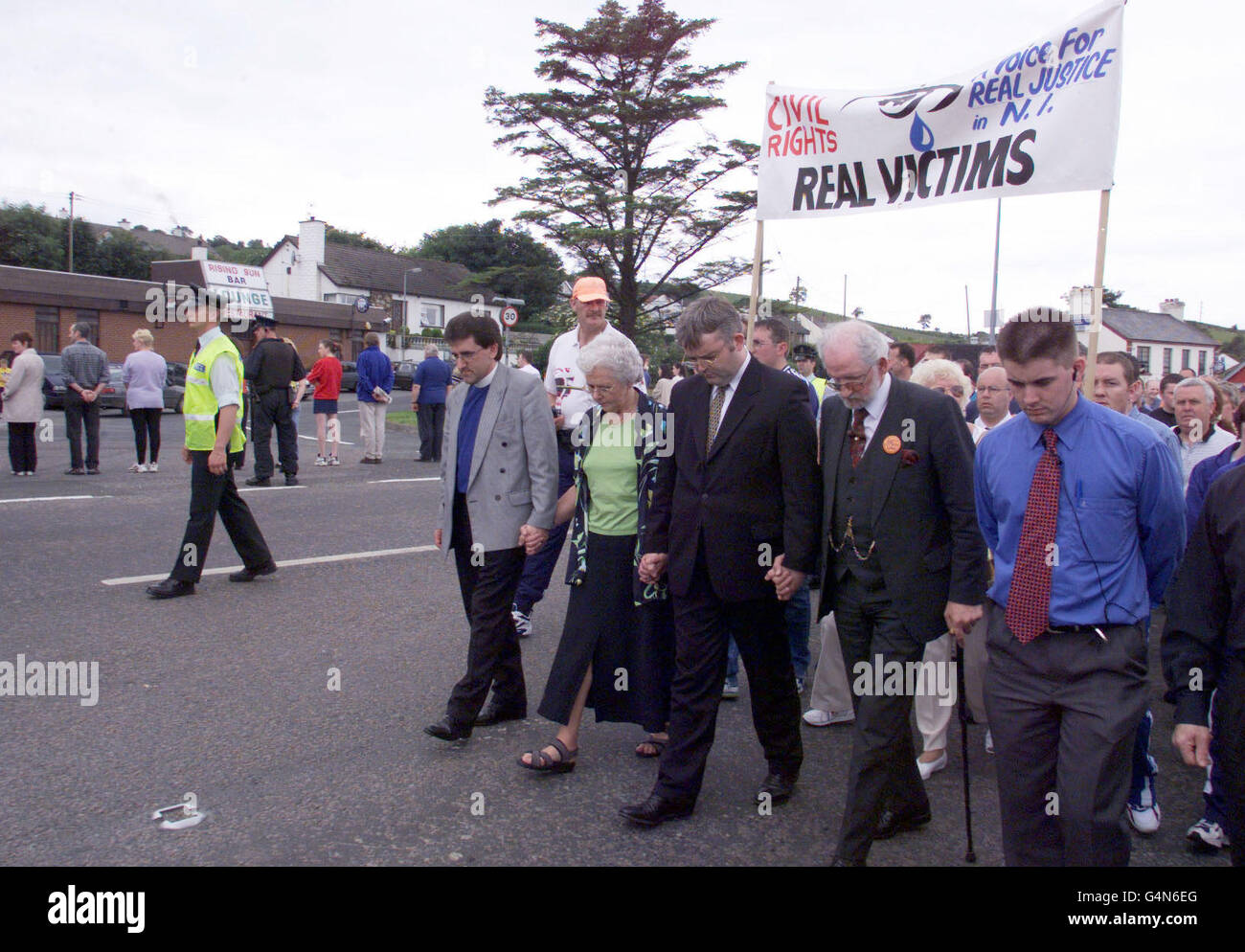 Protestant civil rights marchers bow their heads as they make their way ...