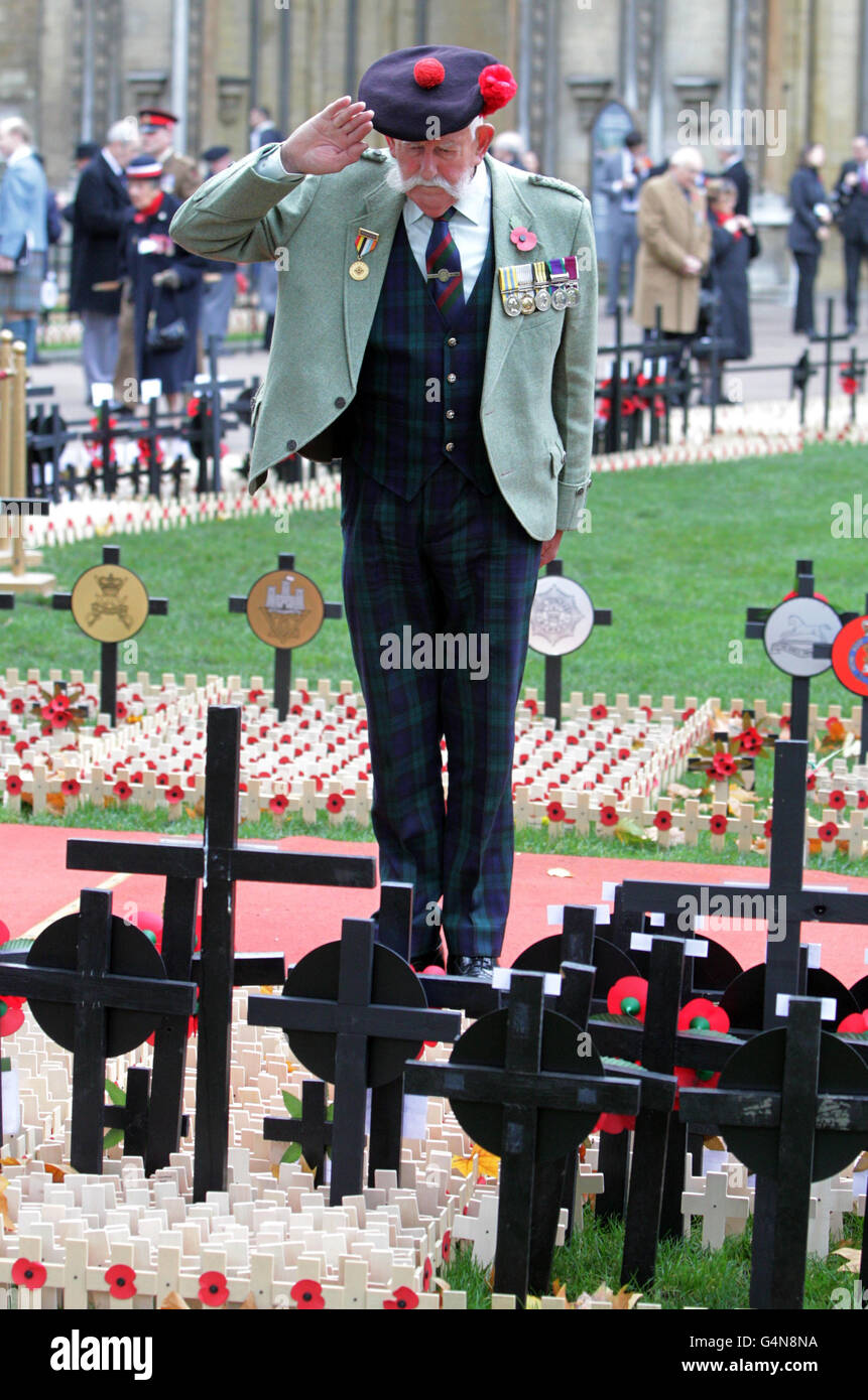 Joe Hubble, from Blackwatch, lays a cross for the Royal West Kent ...