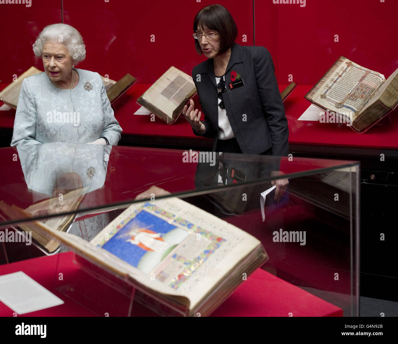 Queen Elizabeth II, accompanied by curator Kathleen Doyle (right) looks ...