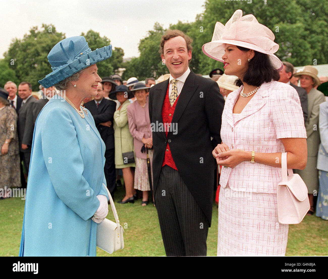 The Queen (L) talks with Dominic Chambers and wife Georgina Kent, at a ...