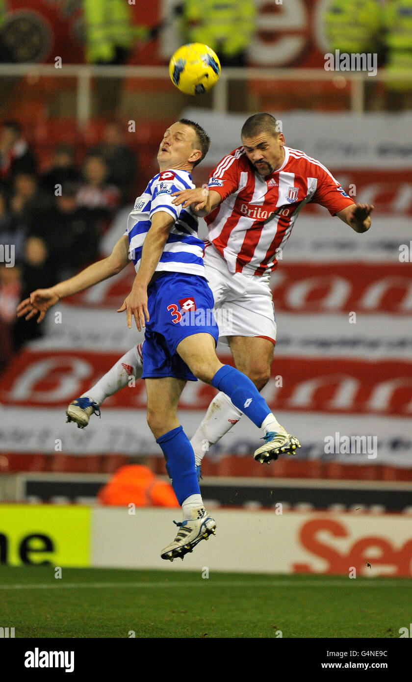 Stoke citys jon walters jumps with queens park rangersclint hill hi-res stock photography and ...
