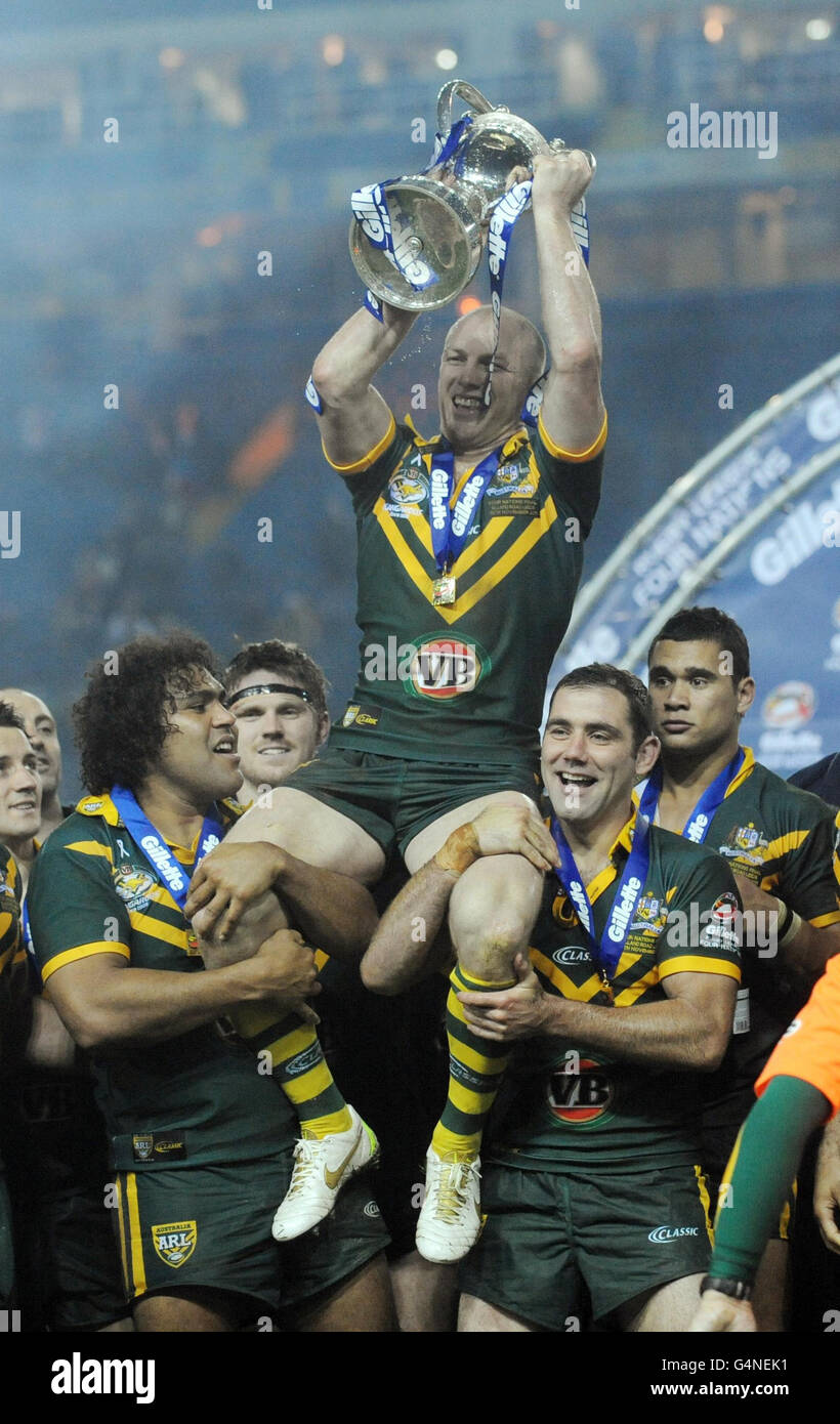 Australia captain Darren Lockyer is lifted up by teammates Sam Thaiday ...
