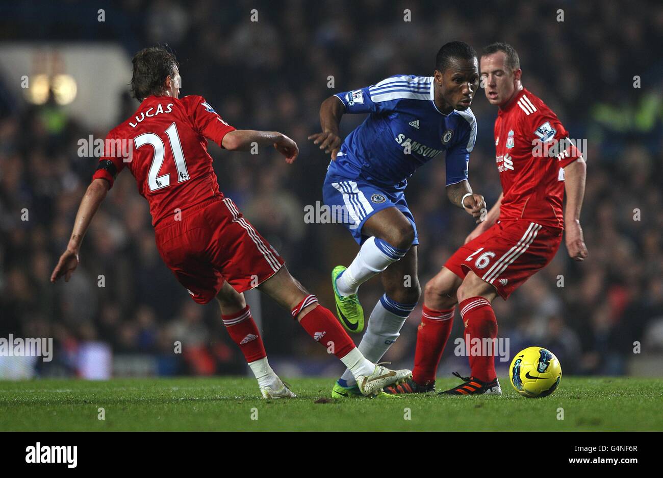 Chelsea's Didier Drogba (centre) gets away from Liverpool's Leiva Lucas ...
