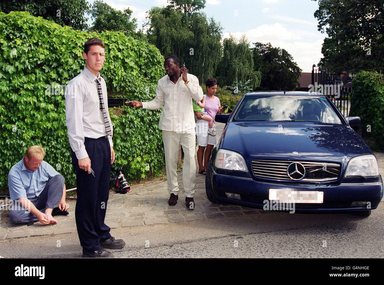Athlete Linford Christie (centre) outside his Buckinghamshire home ...