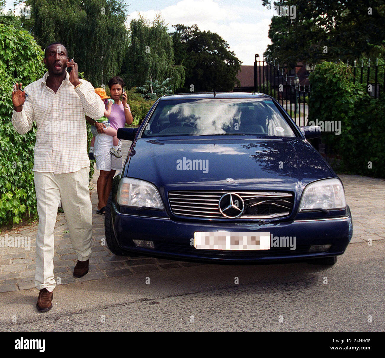 Athlete Linford Christie (centre) outside his Buckinghamshire home ...