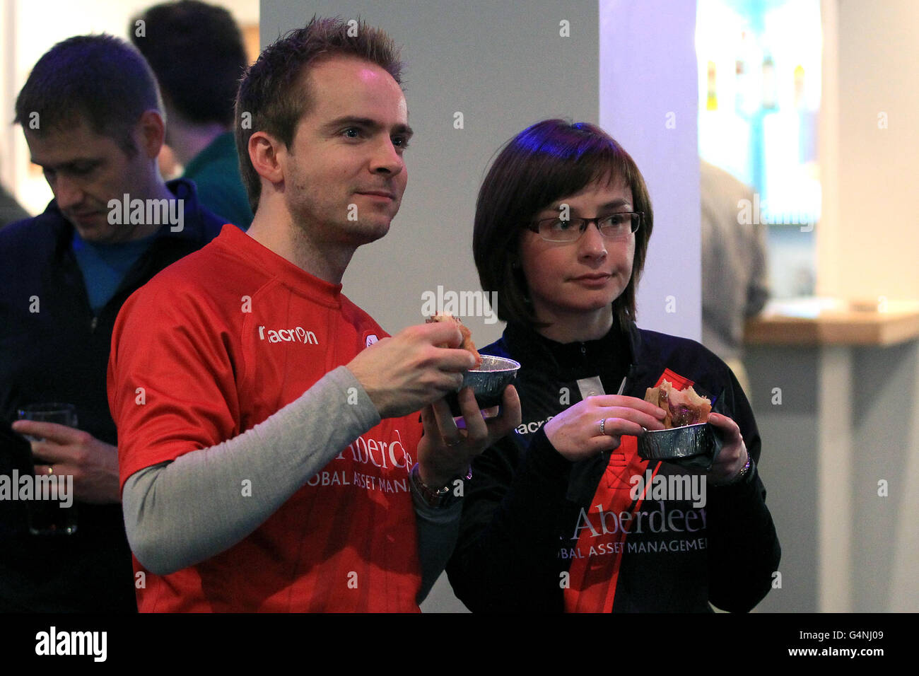 Fans enjoy free pies in the Thistle Bar before kick off Stock Photo - Alamy