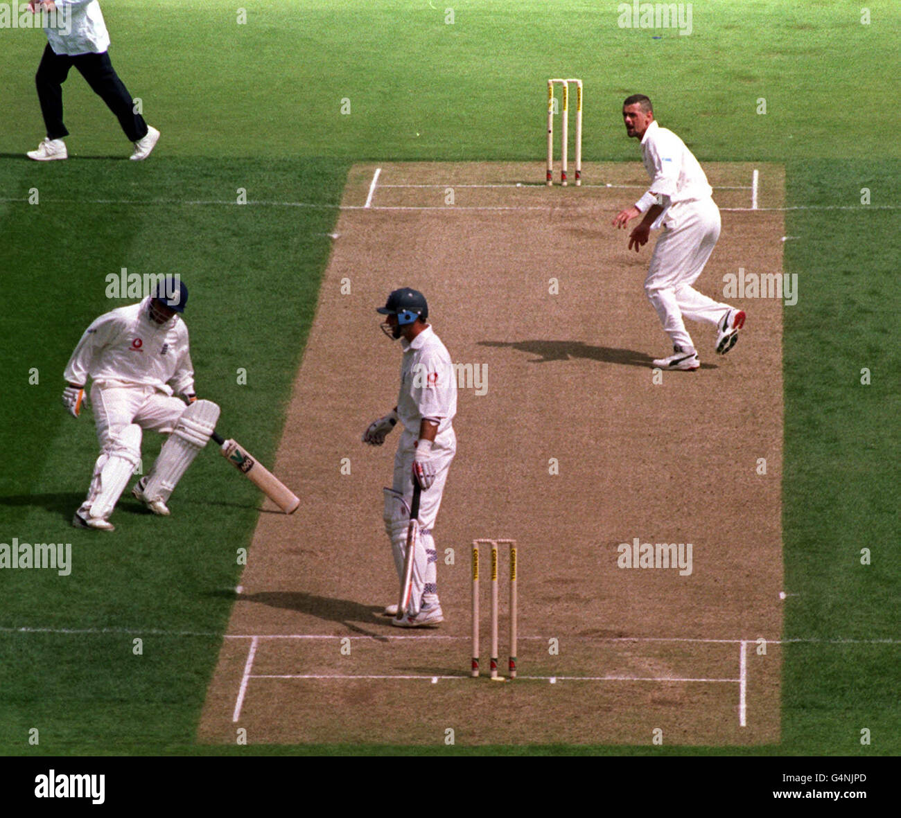 England's captain Nasser Hussain (at crease) watches as Mark Butcher ...