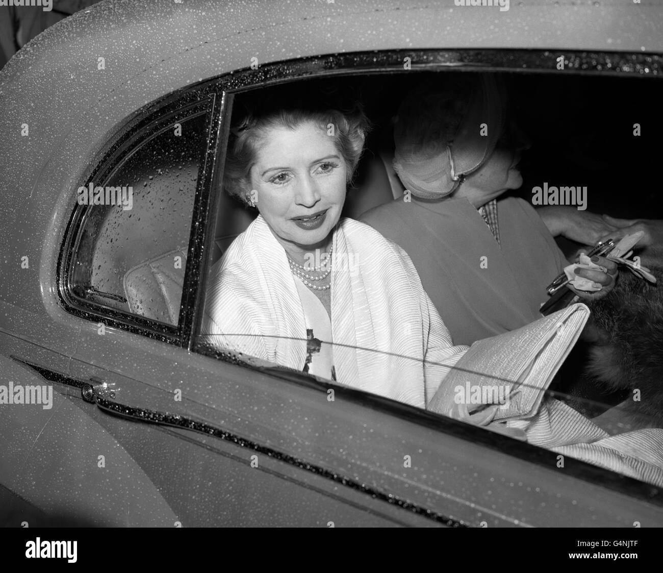 Smiling faintly, Lady Docker pictured in the car as she drove away from ...