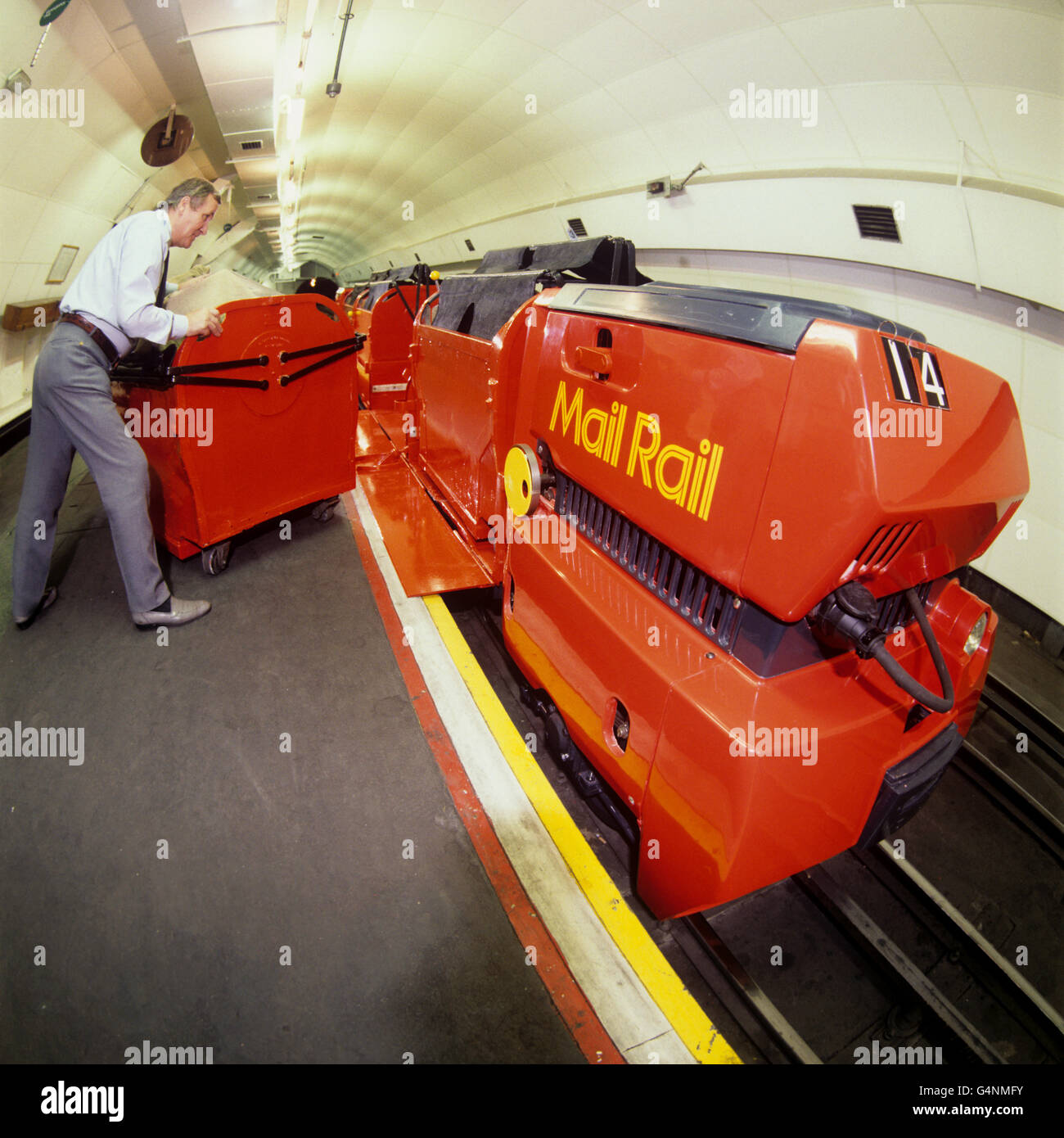 A post office worker loads containers full of mail onto the Royal Mail ...