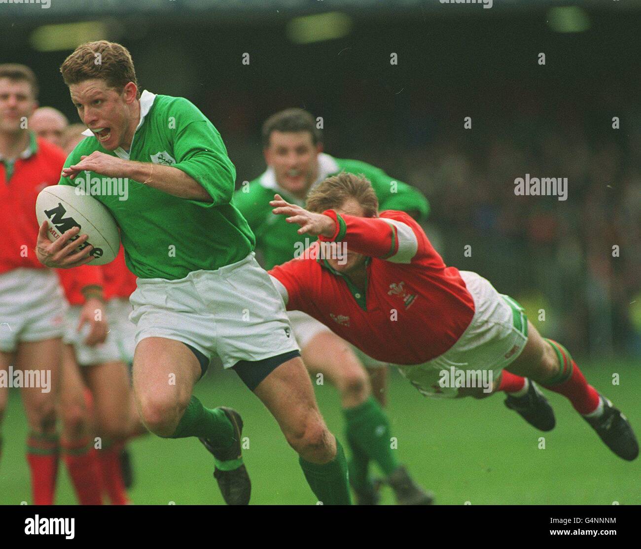 WALES' MIKE HALL TRIES IN VAIN TO STOP BRENDAN MULLIN, IRELAND, FROM ...