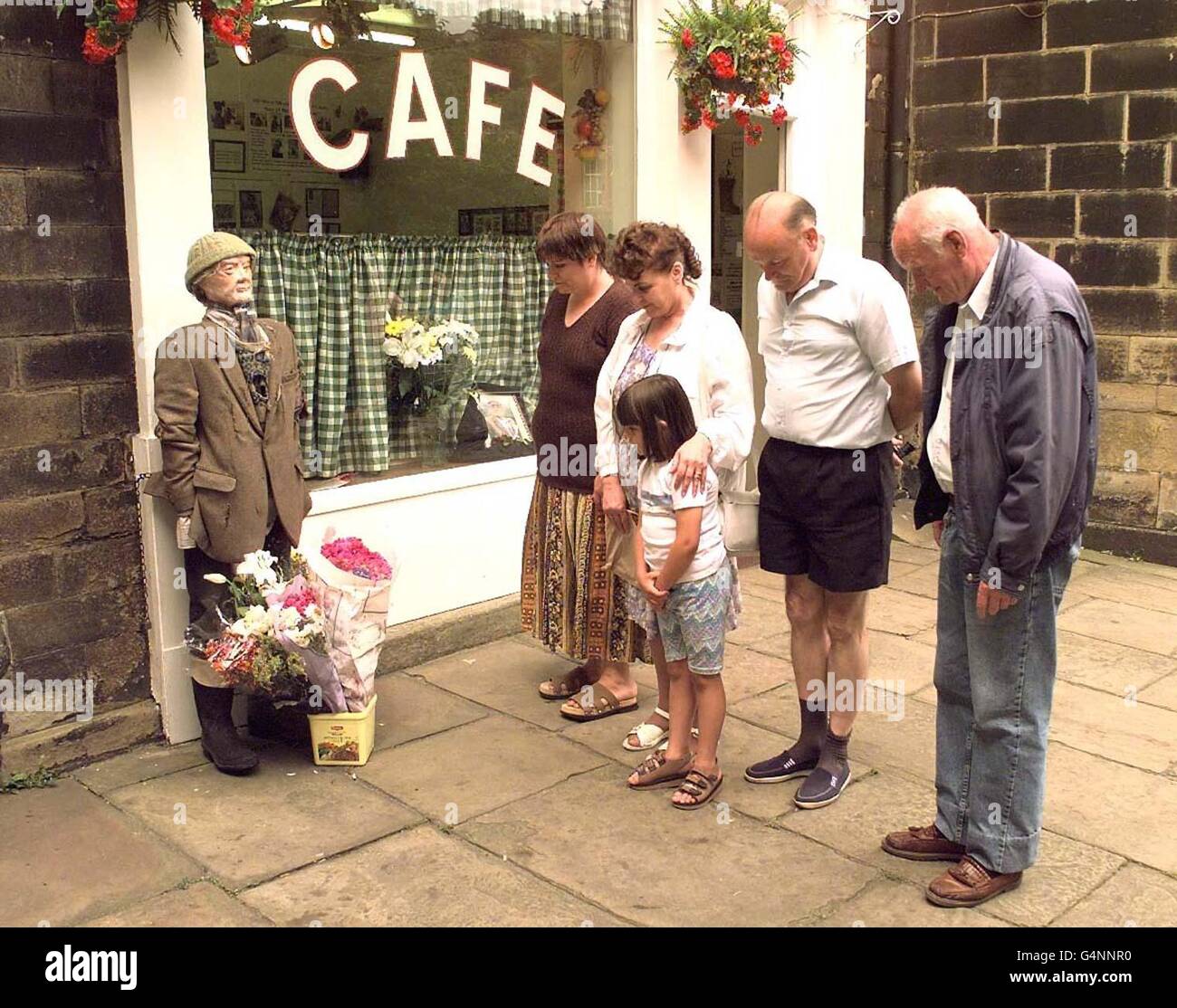 The Bunn family from Suffolk place flowers at a model of Compo the ...