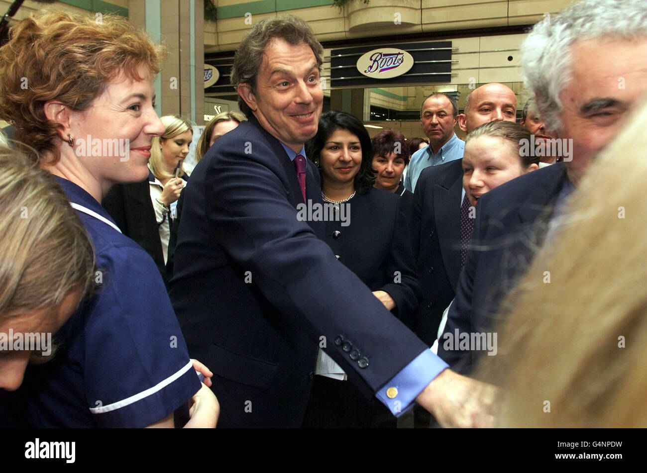 British Prime Minister Tony Blair hands out leaflets promoting the NHS ...