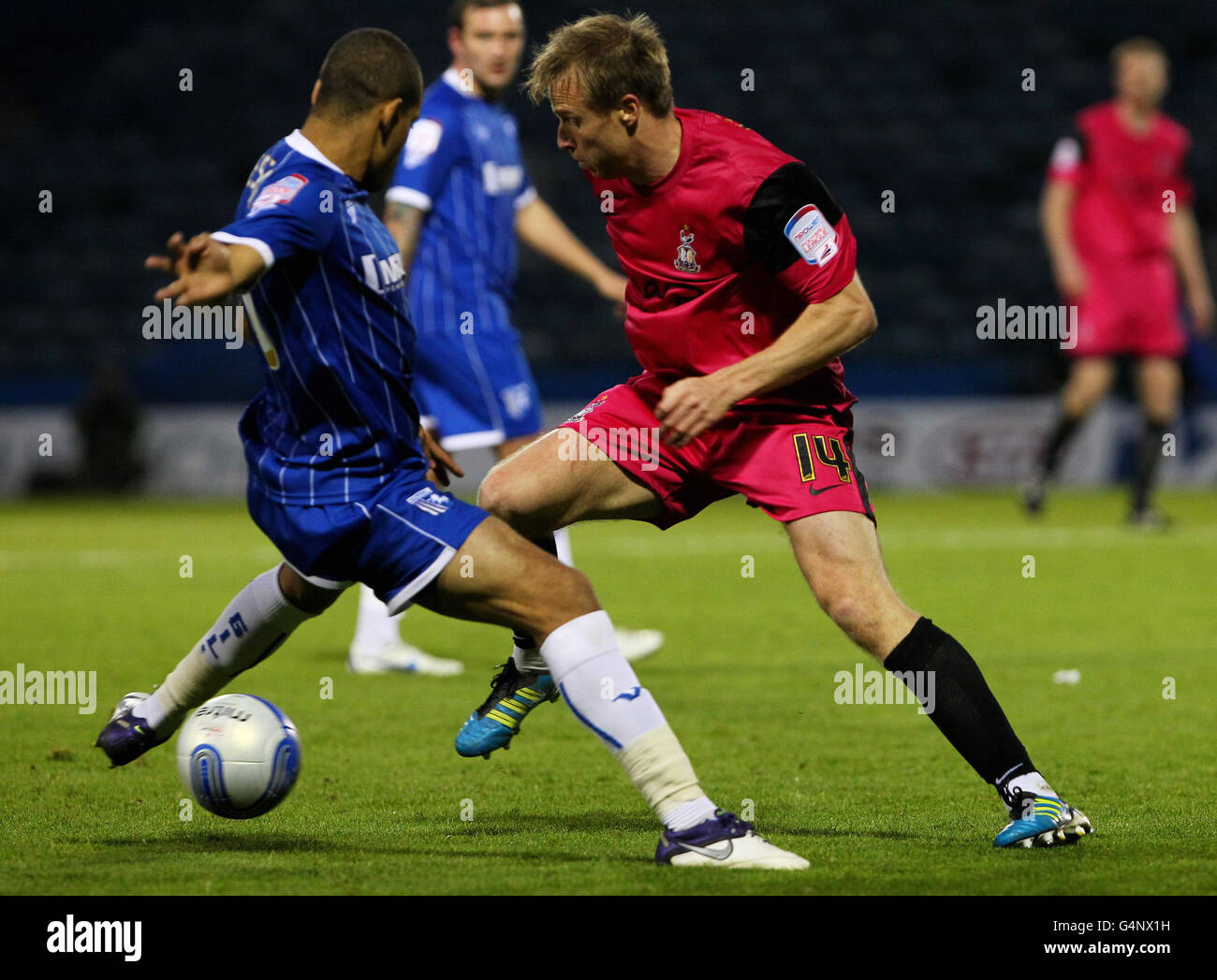 Bradford's Ricky Ravenhill takes on Gillingham's Curtis Weston during ...