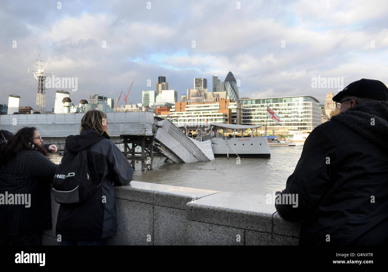 Members of the public look-on after the gangway leading to HMS Belfast ...