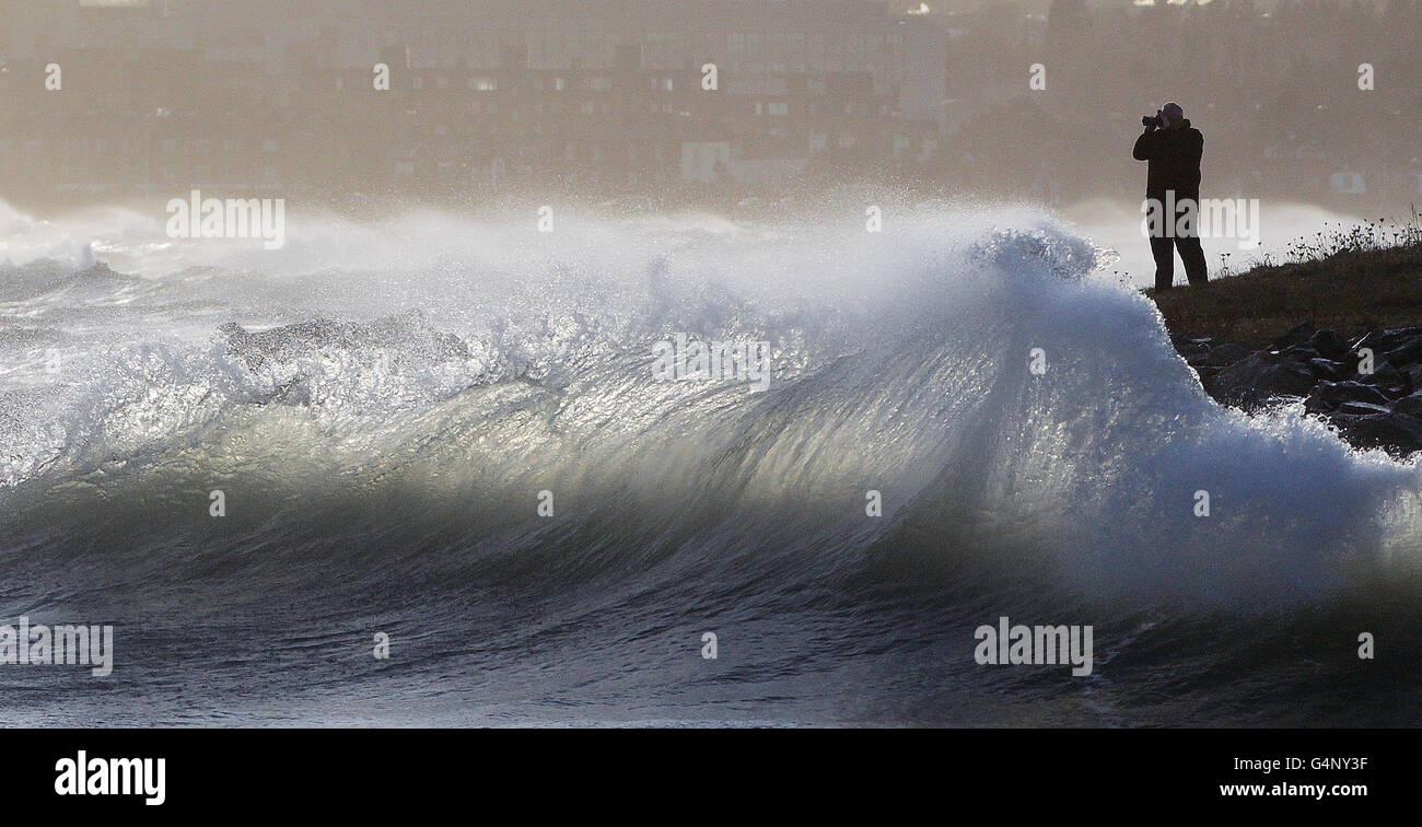 A member of the public photographs waves during high winds at Dublin's ...