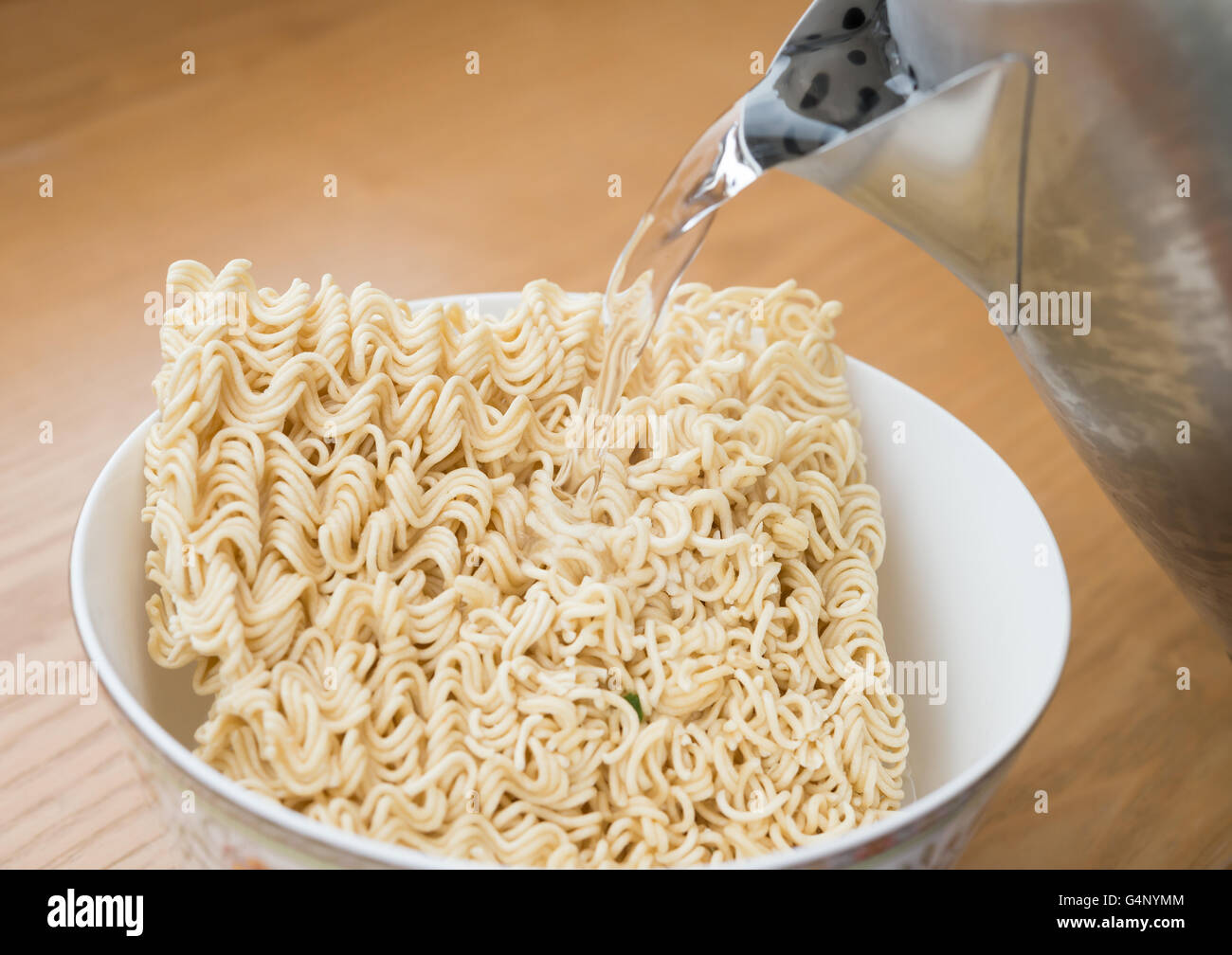pouring water to prepare instant noodles Stock Photo - Alamy