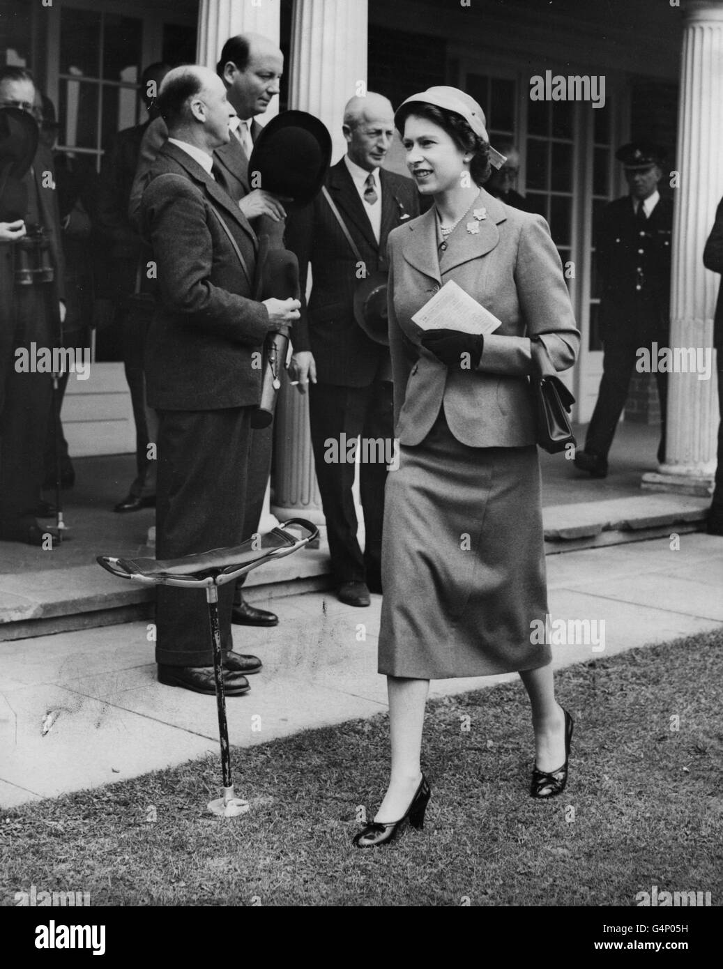 Queen Elizabeth II walks to the paddock during her visit to Newmarket ...