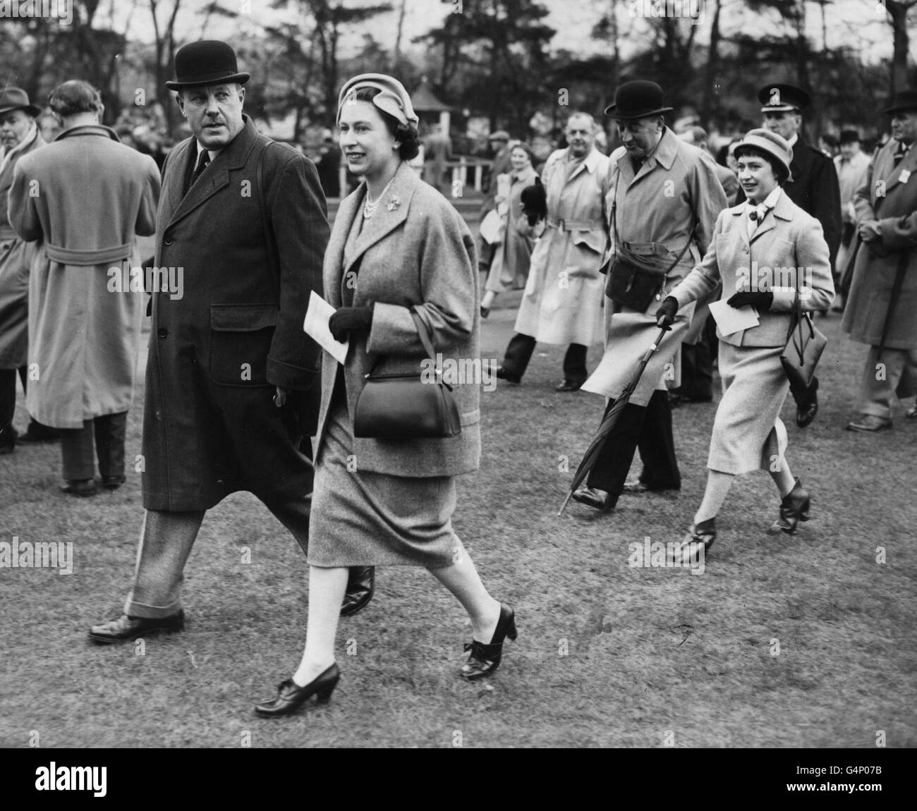 Queen Elizabeth II, followed by Princess Margaret walking to the ...
