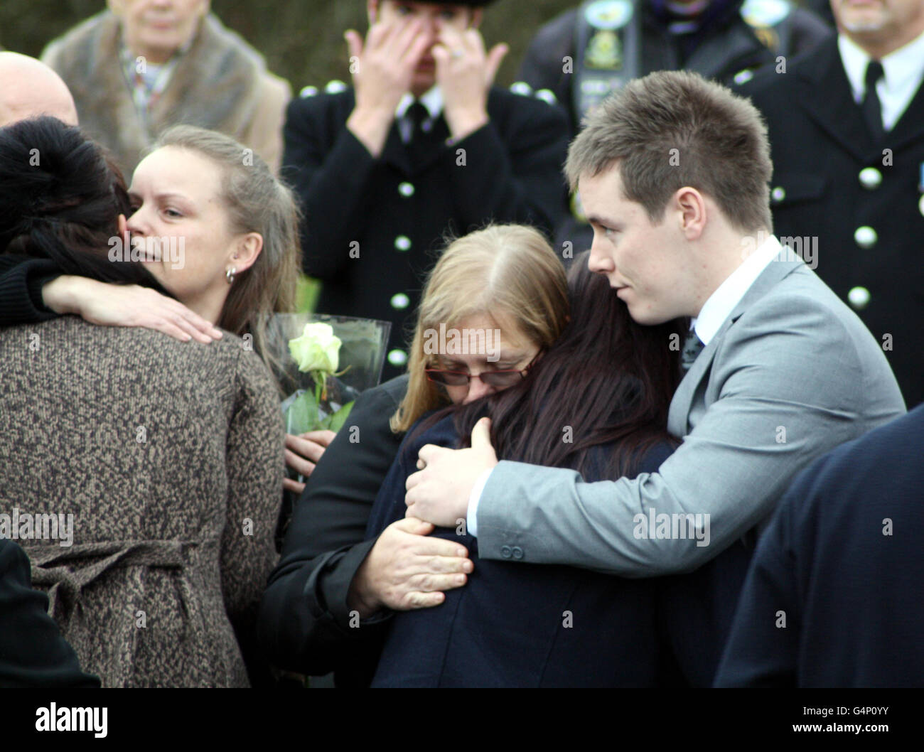 Family members comfort each other before the body of Rifleman Sheldon ...