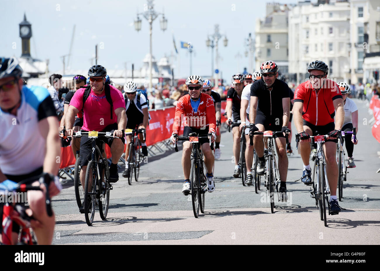 Brighton, UK. 19th June 2016. Cyclists cross the finishing line ...