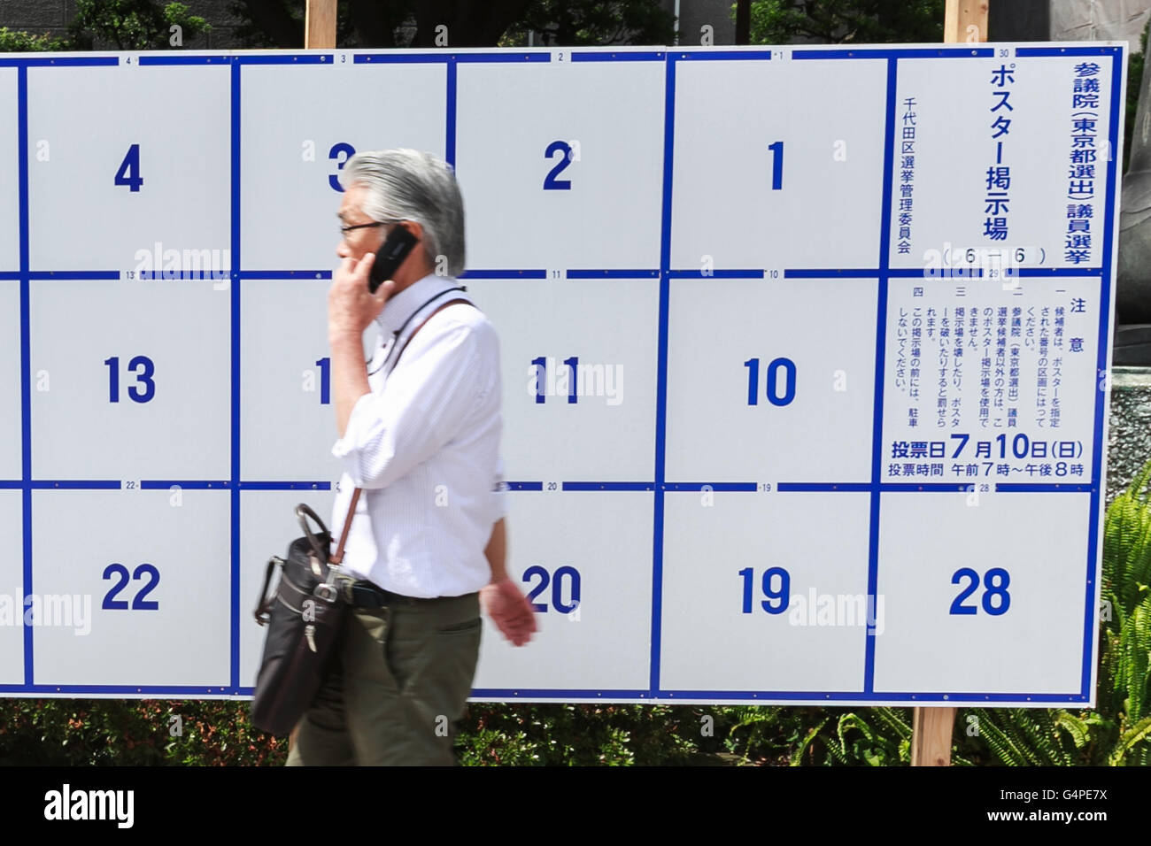 Man putting up posters hi-res stock photography and images - Alamy