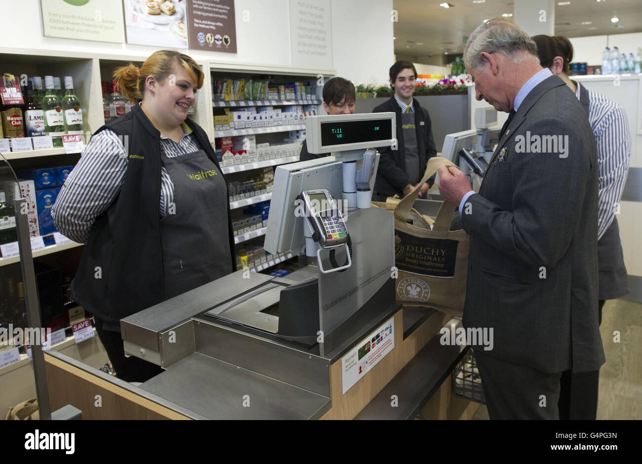 The Prince of Wales is given a bag of produce at the checkout during ...
