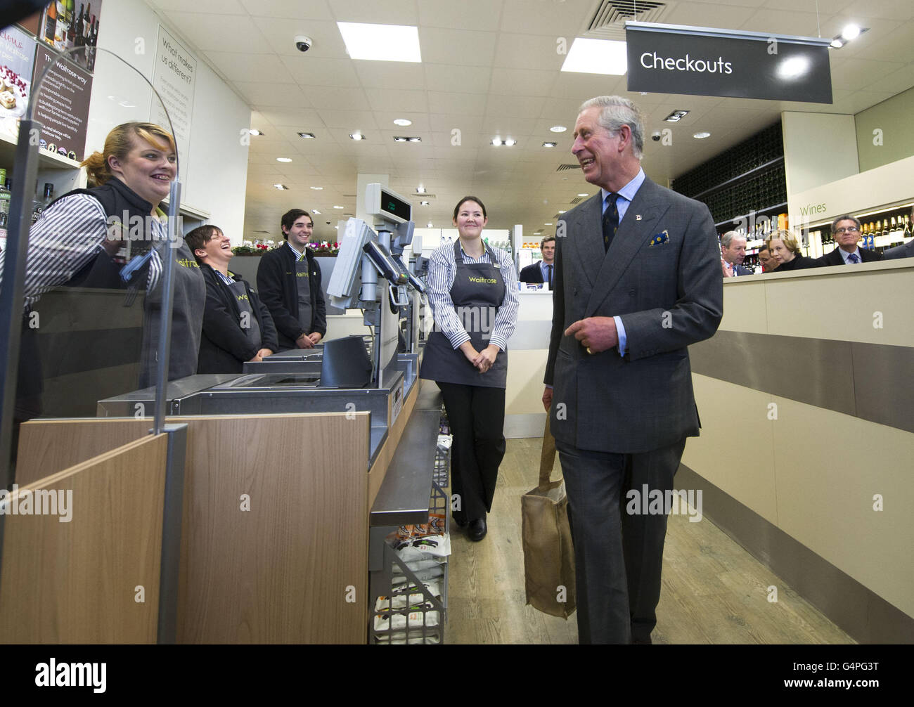 The Prince of Wales carries out the bag of produce he was given during ...