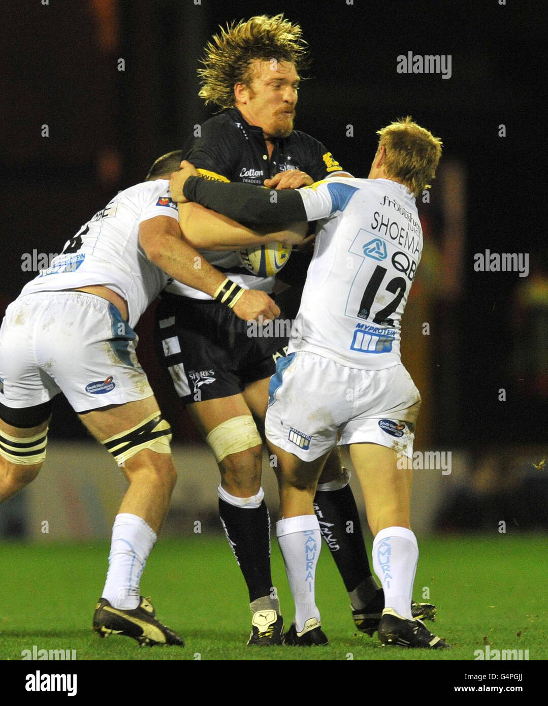 Sale Sharks Andy Powell is tackled by Exeter Chiefs Tom Hayes (left ...