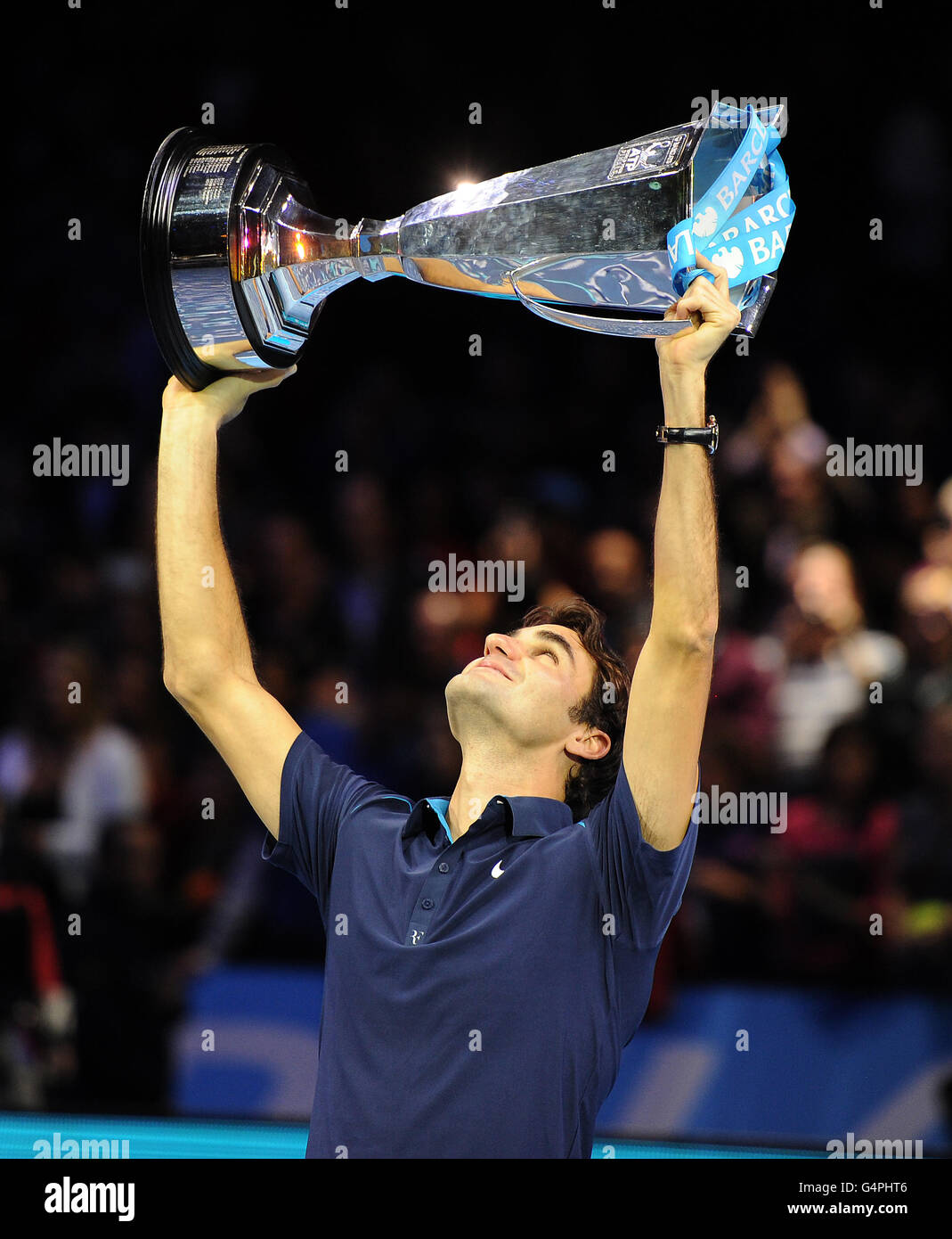 Switzerland's Roger Federer holds the trophy after beating France's Jo ...