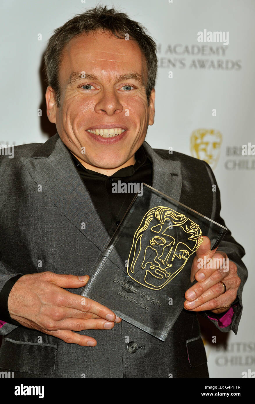 Warwick Davis holds his award at the British Academy Children's Awards ...